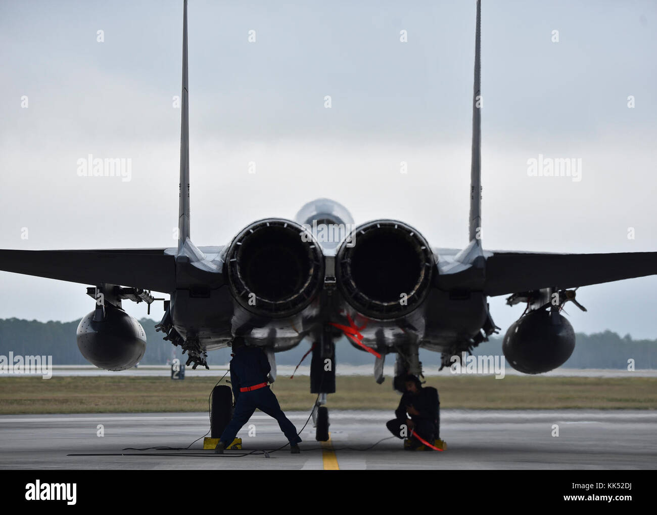 U.S. Air Force Airmen inspect the underbelly of an F-15E Strike Eagle ...