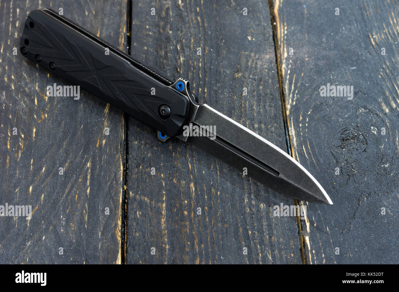 Black knife wooden background. Black texture. Diagonal Stock Photo - Alamy