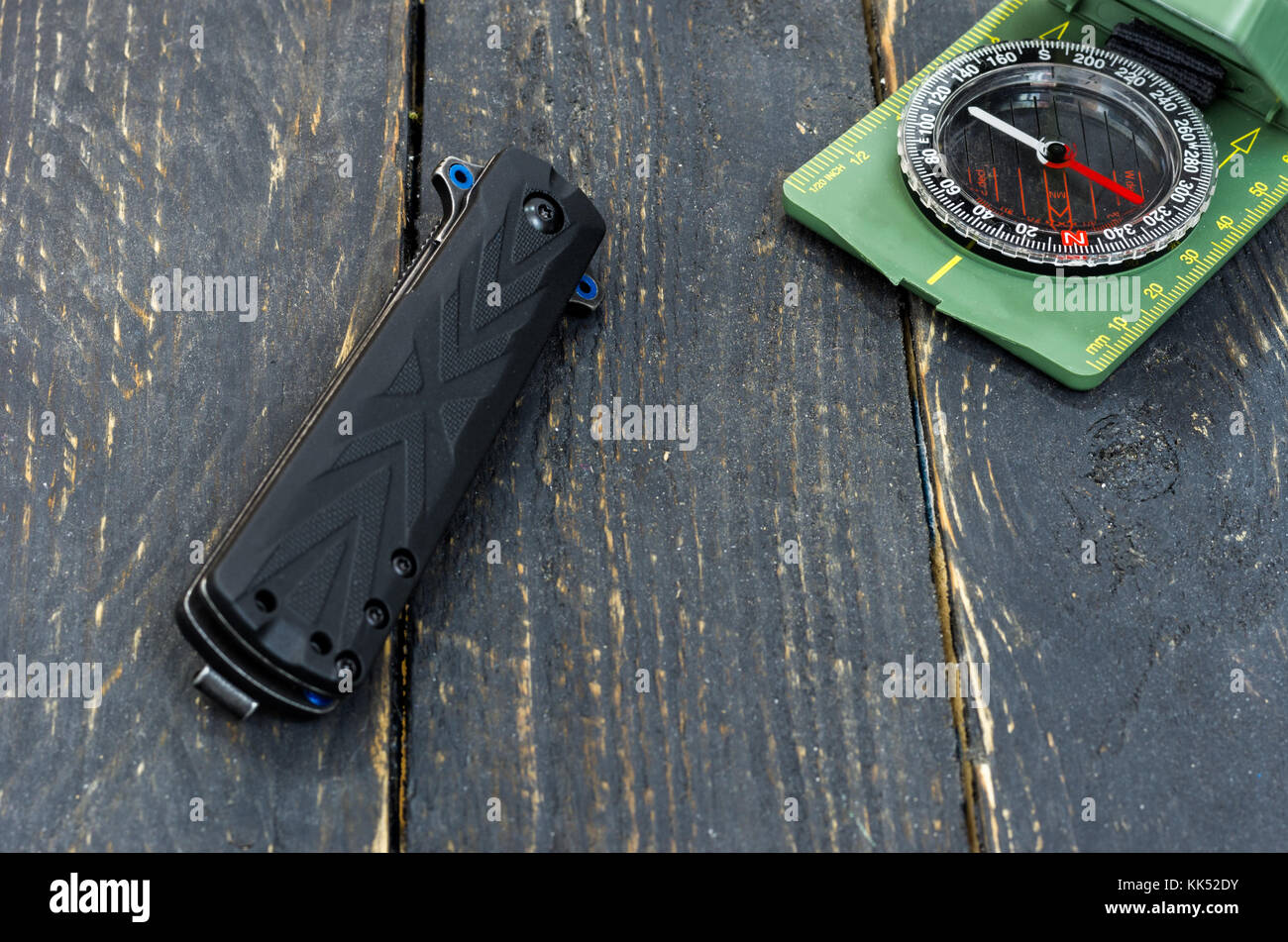 Tourist image. Composition of a knife and a compass Stock Photo - Alamy