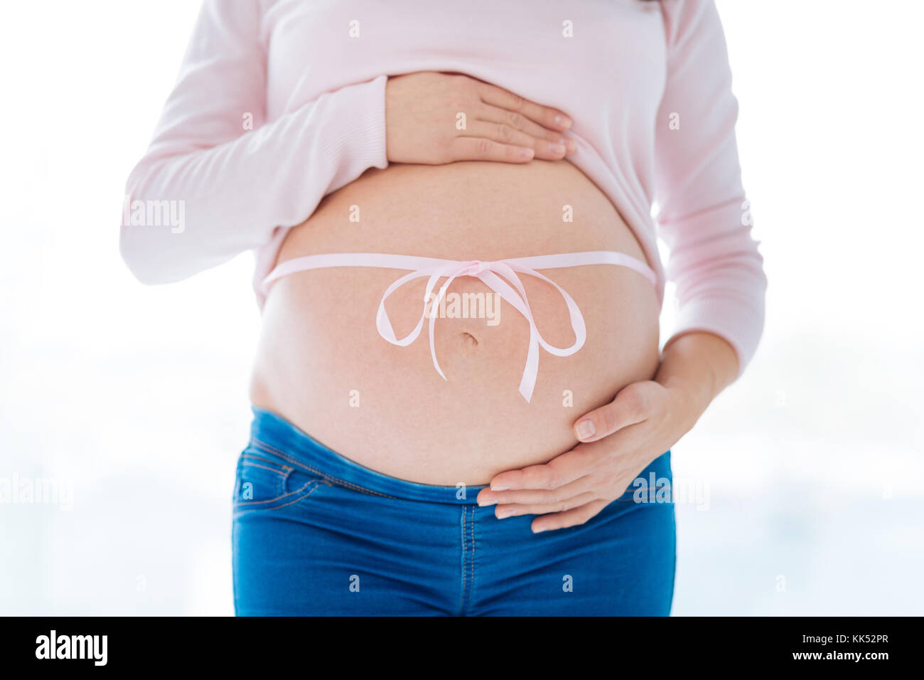 Pregnant belly pink ribbon hi-res stock photography and images - Alamy