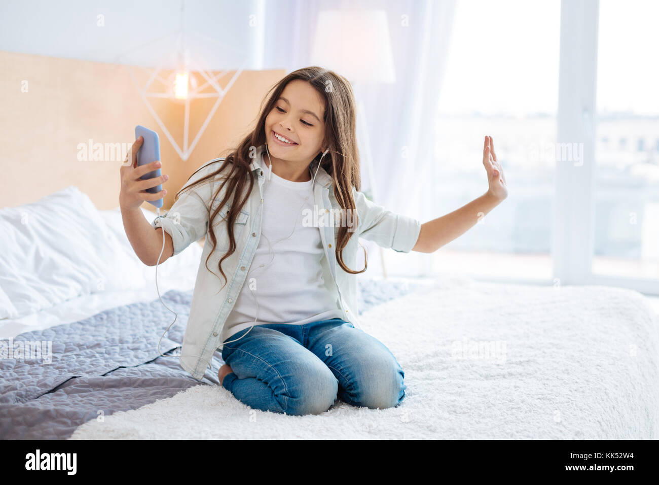 Dancing in blood. Sweet cute nice girl dancing and looking at the phone ...