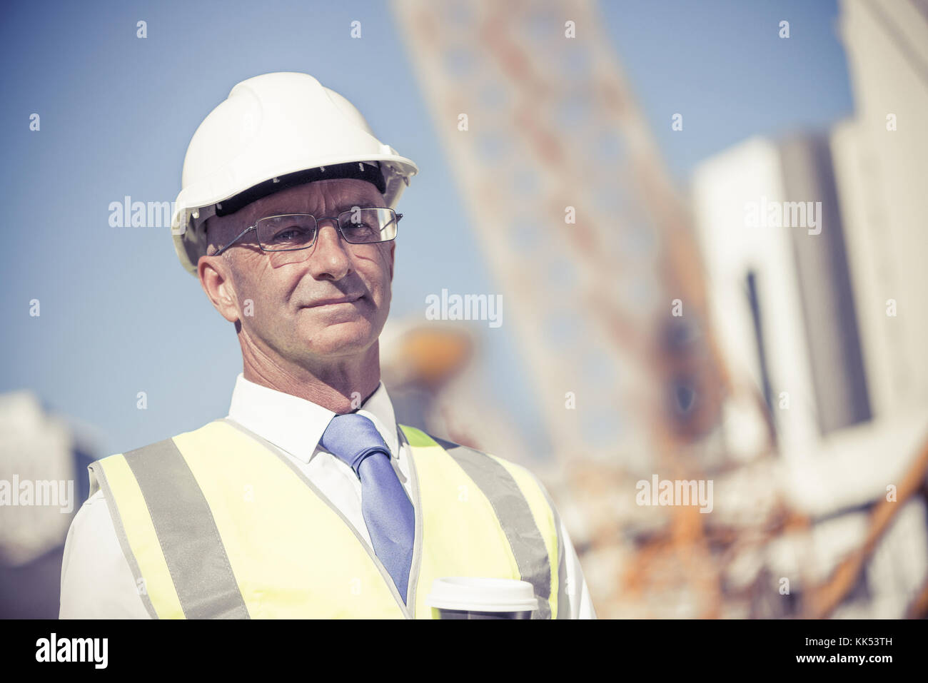 Senior foreman in glasses doing his job at building area on sunn Stock ...