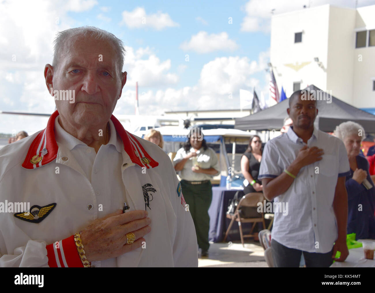 A United State military veteran stands with hand over heart to show his ...