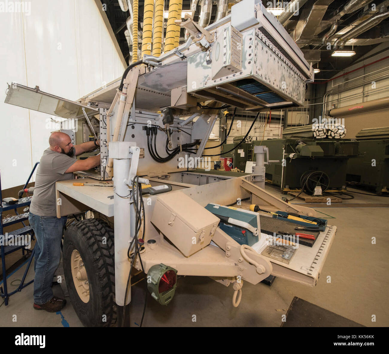 Electronics Mechanic Joseph Brungard makes an adjustment to a ...