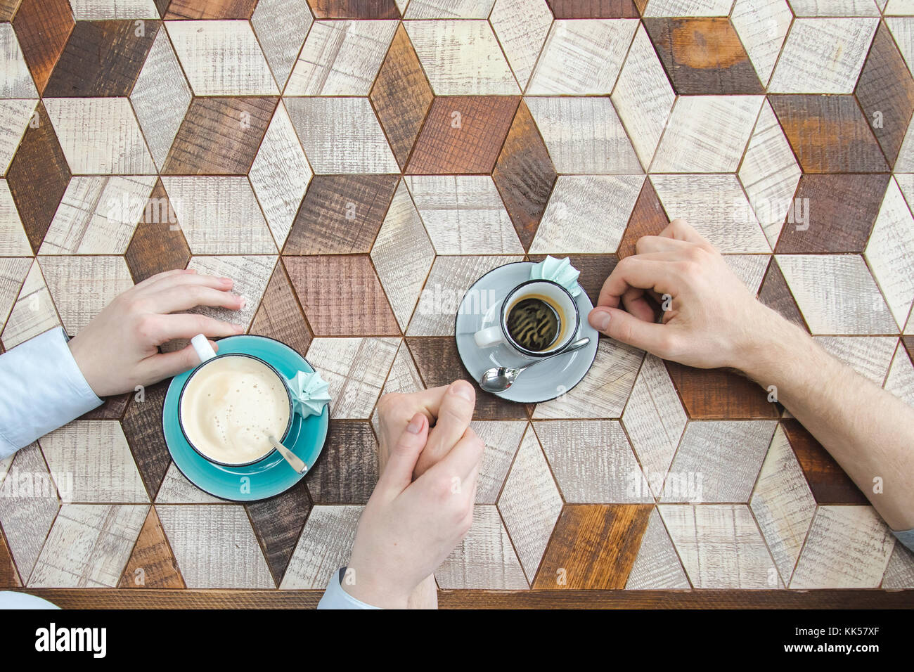 Top view couple holding by hands drinking coffee Stock Photo - Alamy