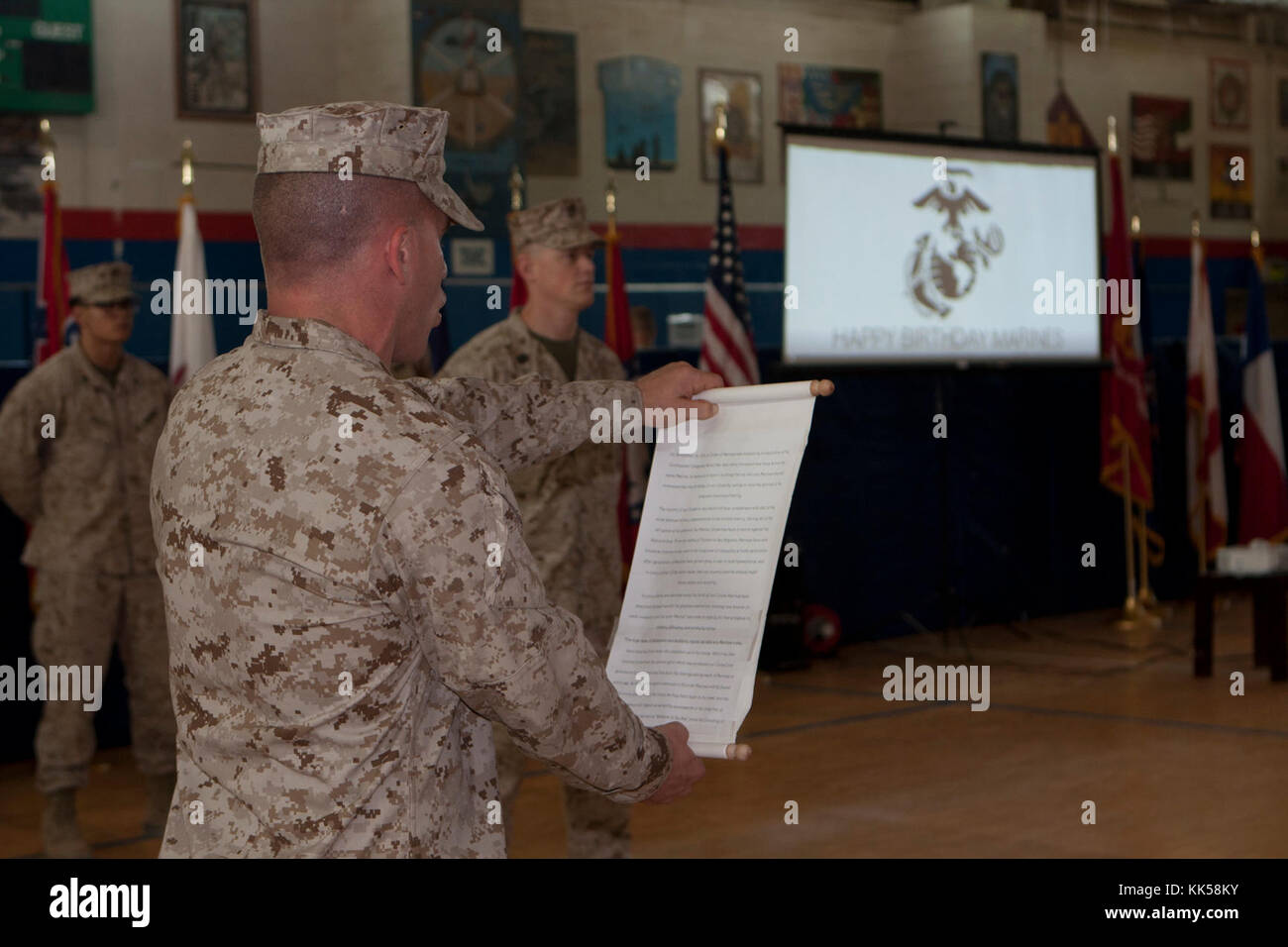 Capt. James Patterson, a U.S. Marine adjutant for the ceremony, reads a ...