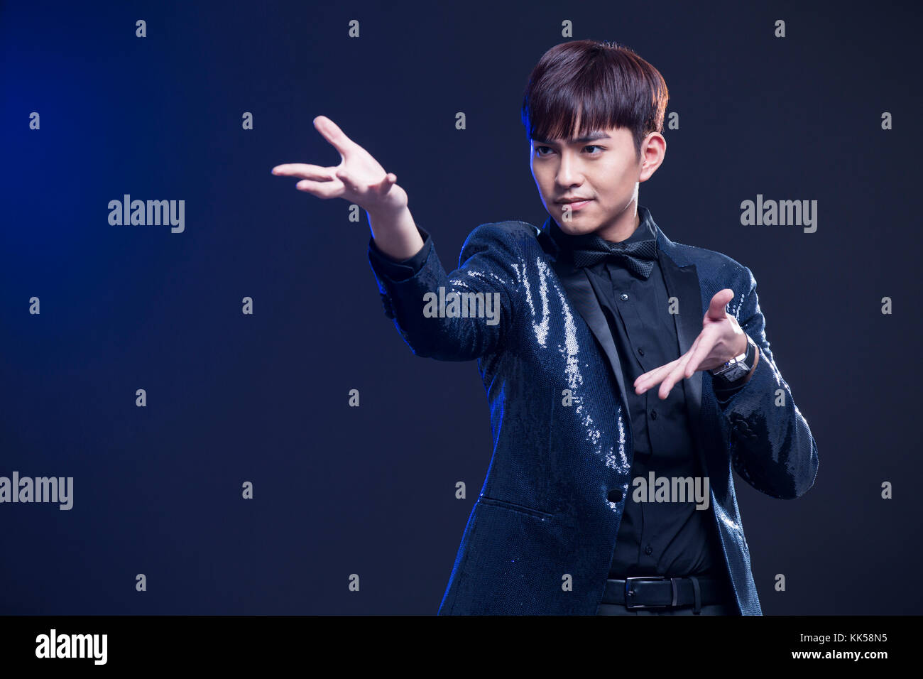 Young Chinese magician performing magic trick Stock Photo - Alamy