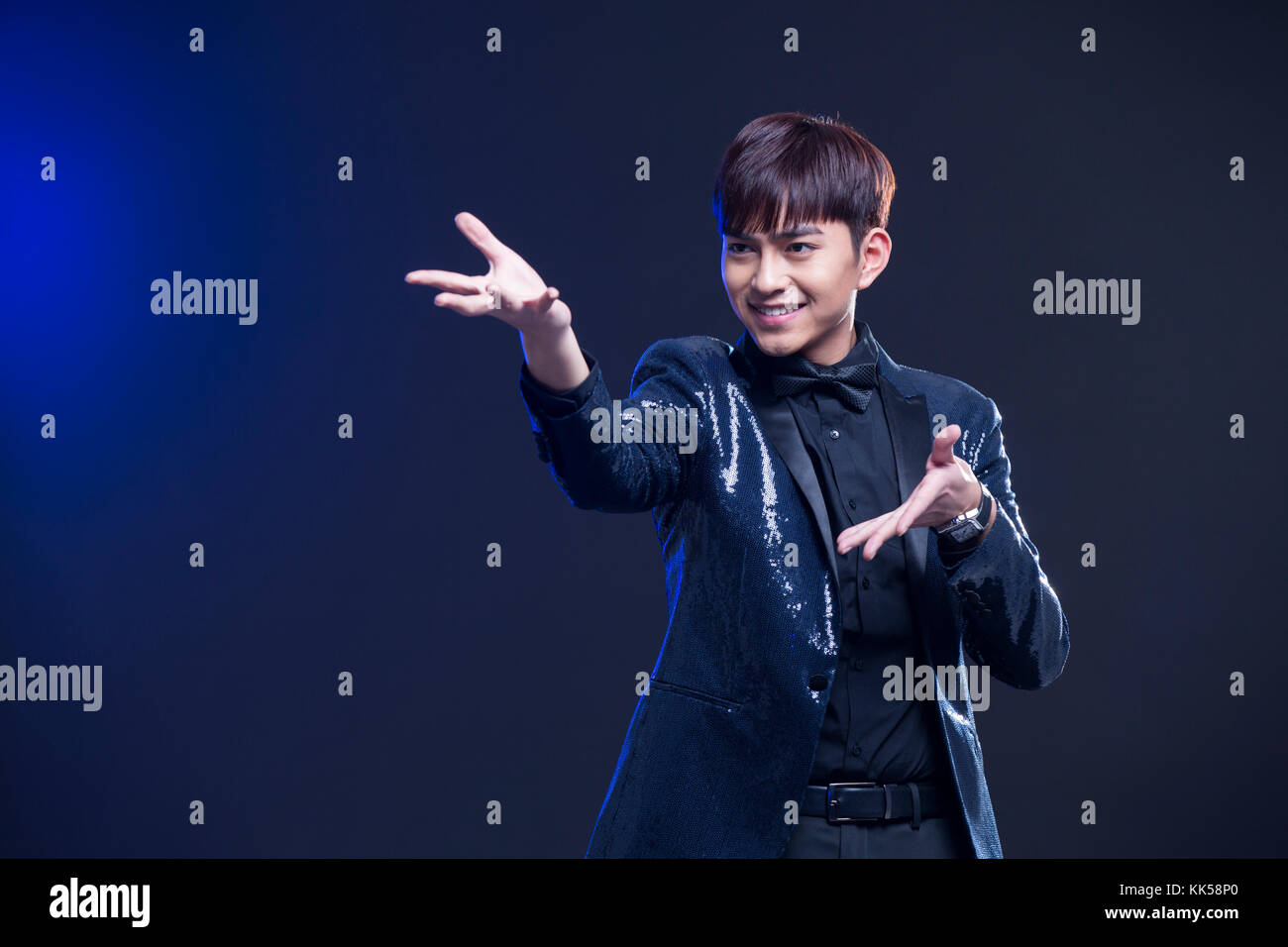 Young Chinese magician performing magic trick Stock Photo - Alamy