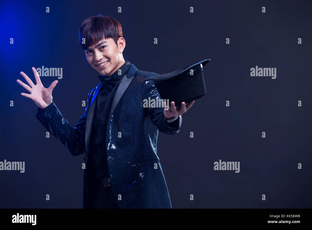 Young Chinese magician performing magic trick Stock Photo - Alamy