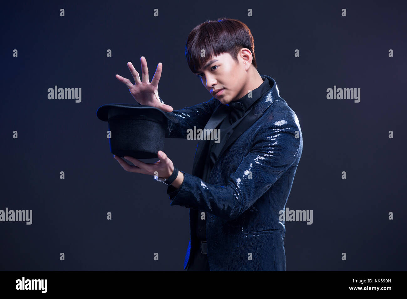 Young Chinese magician performing magic trick Stock Photo - Alamy