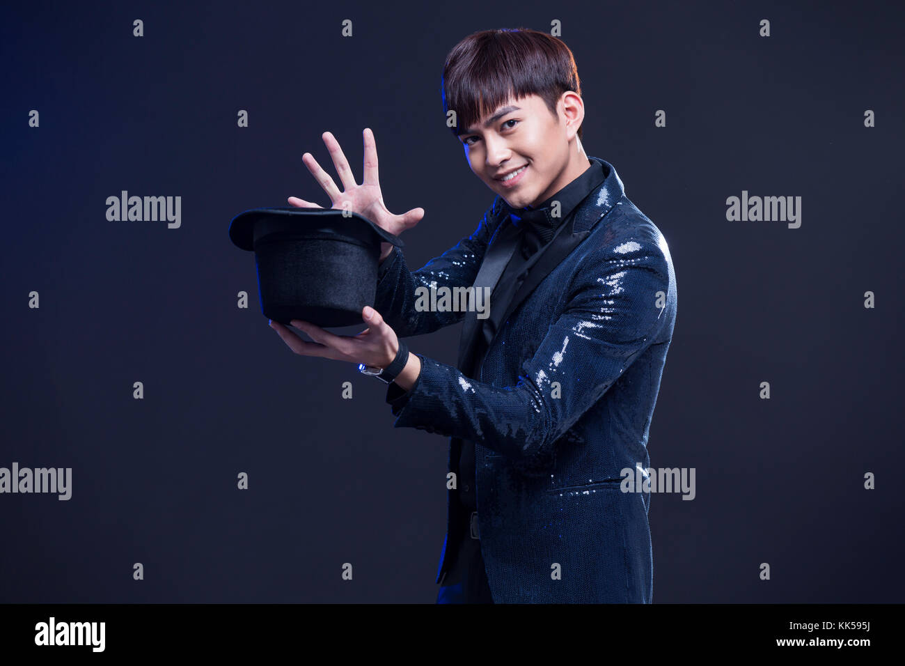 Young Chinese magician performing magic trick Stock Photo - Alamy
