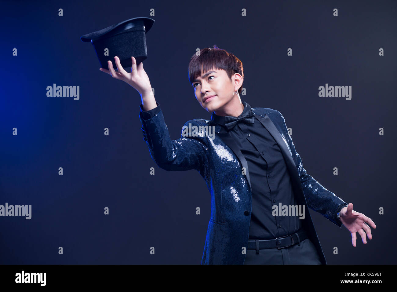 Young Chinese magician performing magic trick Stock Photo - Alamy