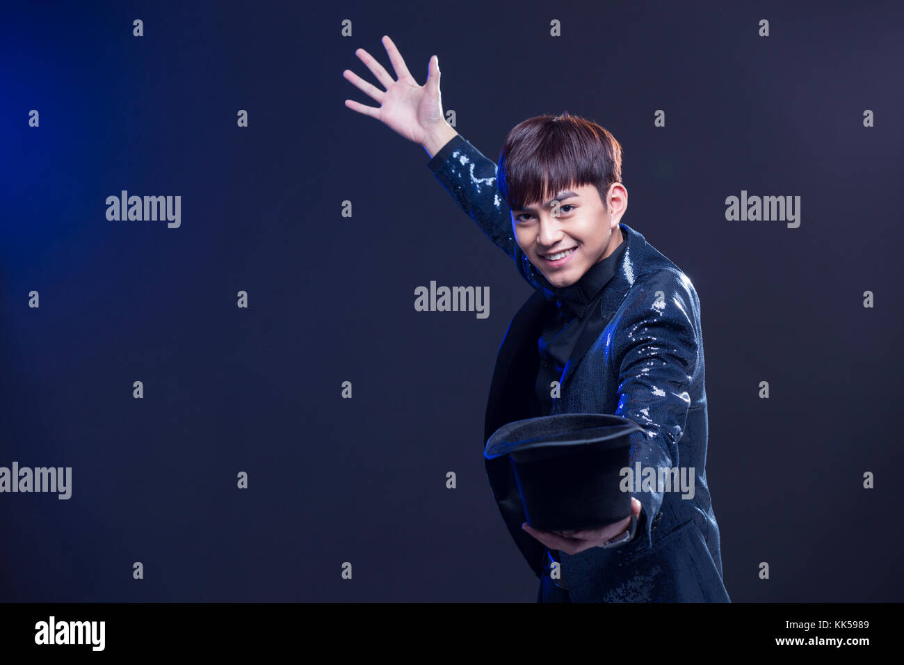 Young Chinese magician performing magic trick Stock Photo - Alamy