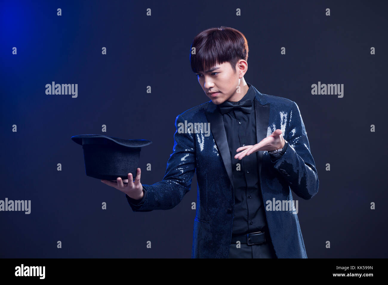Young Chinese magician performing magic trick Stock Photo - Alamy