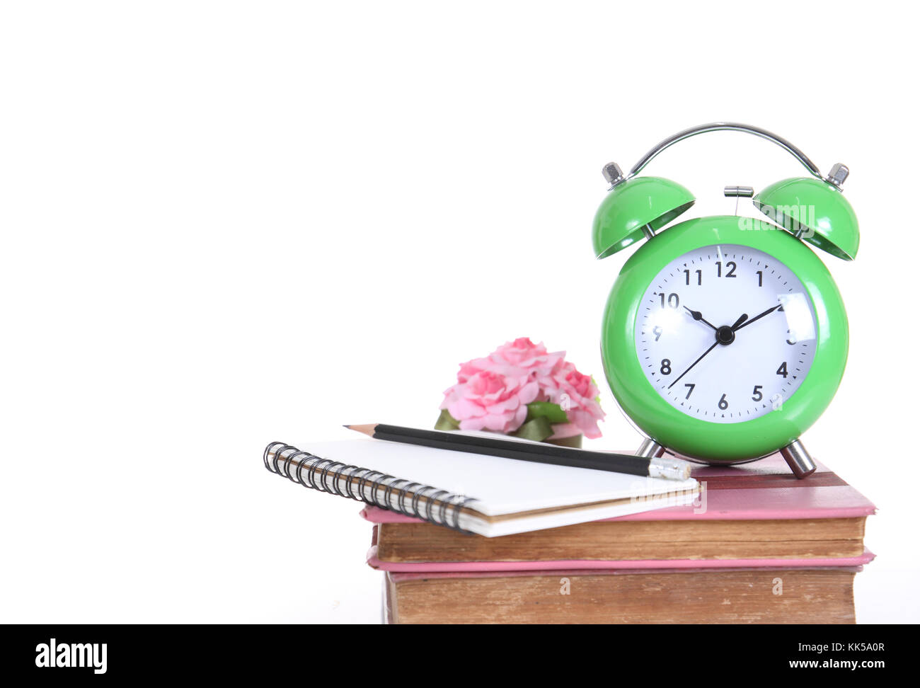 Alarm clock with pencil and notebook background Stock Photo - Alamy