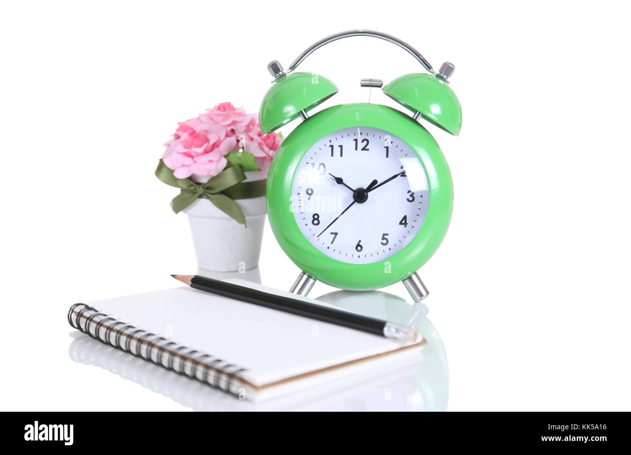 Alarm clock with pencil and notebook background Stock Photo - Alamy