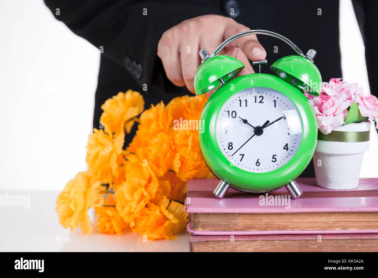 businessman pointing to alarm clock Stock Photo - Alamy