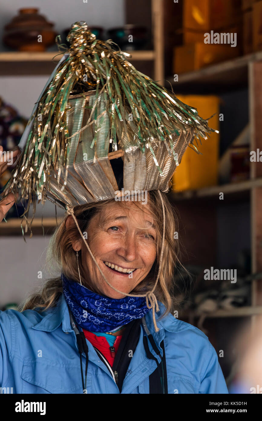 CARROLL DUNHAM wears a funny hat in a shop at LAMAYURU - LADAKH, INDIA ...