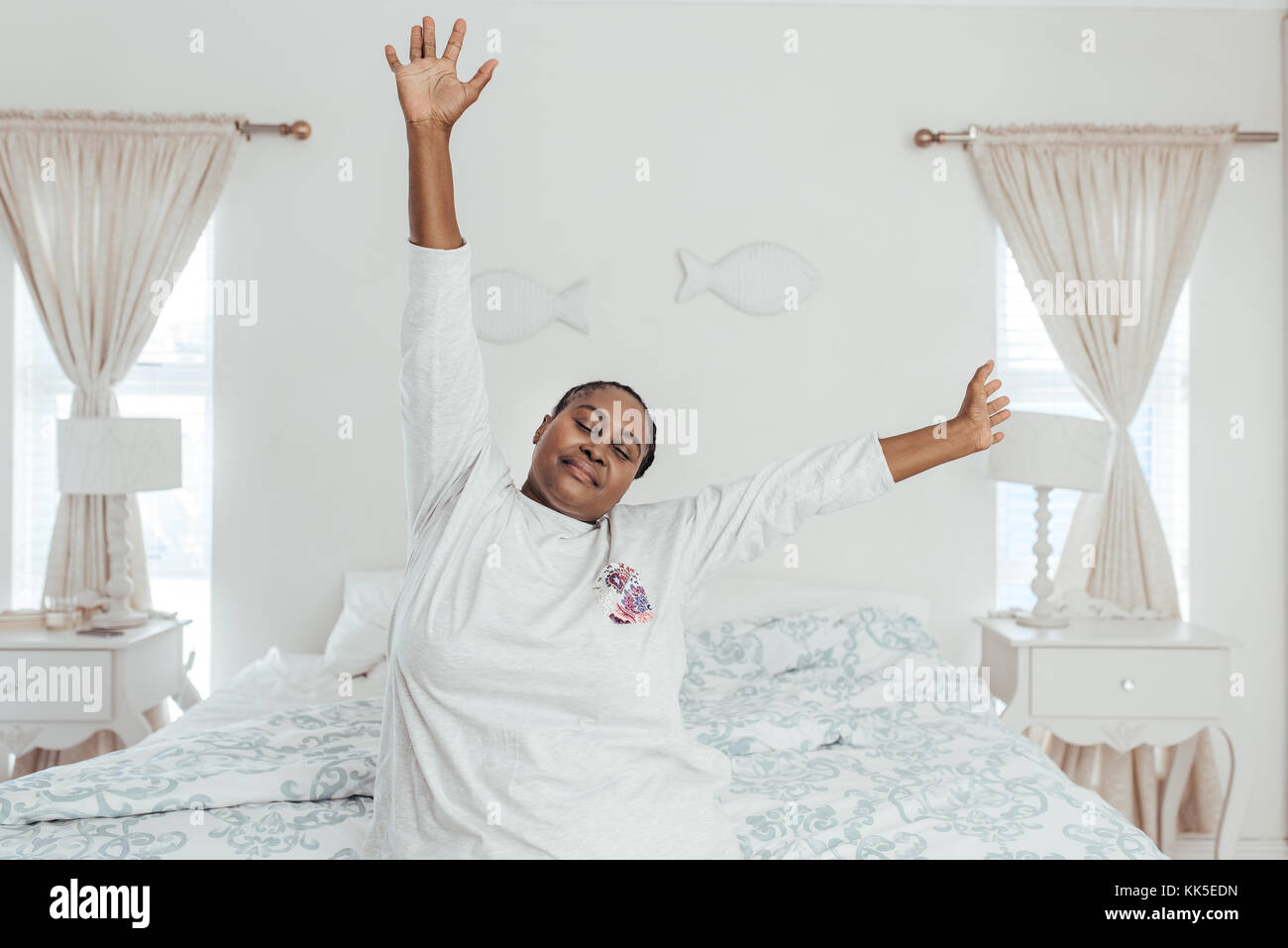 Attractive woman waking up stretching hi-res stock photography and ...