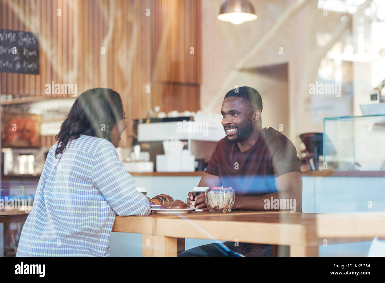 Young African couple talking together over coffee in a cafe Stock Photo ...