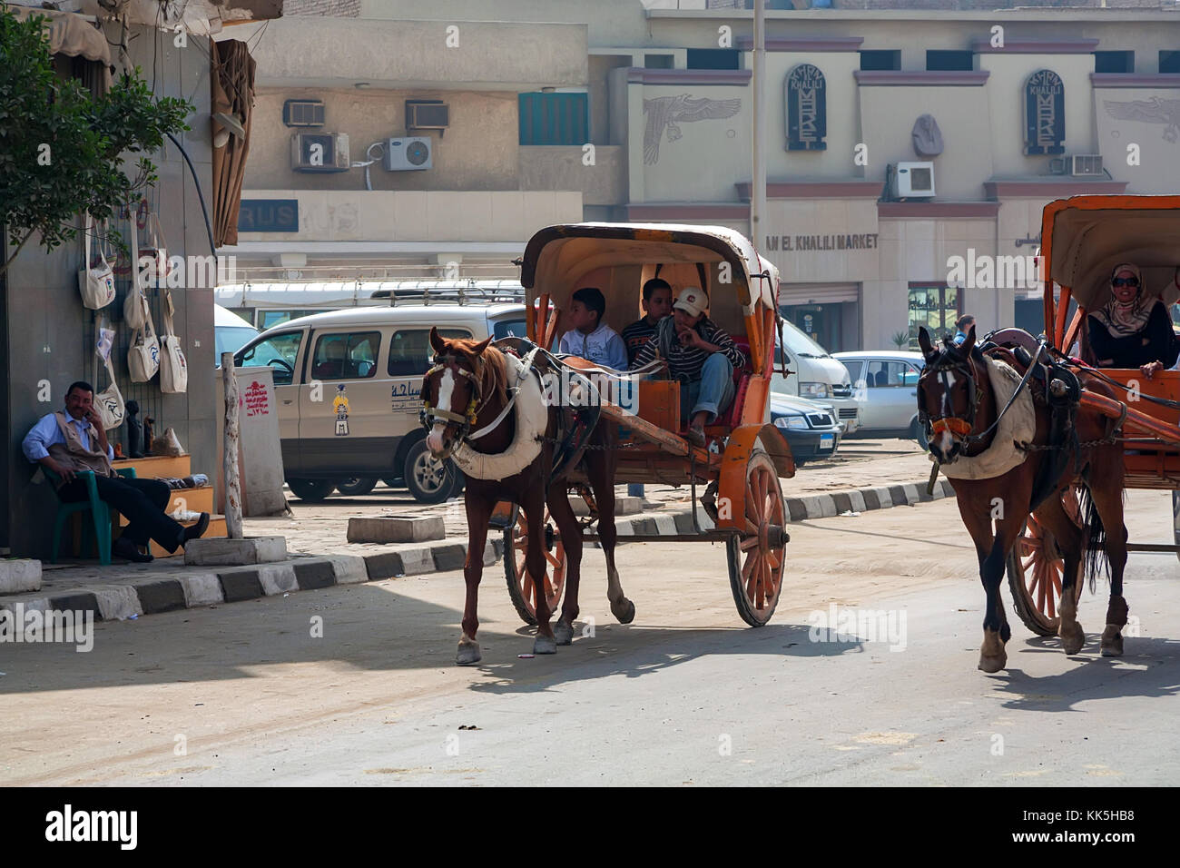 GIZA, EGYPT - FEBRUARY 2010: Horse carriages on city street Stock Photo ...