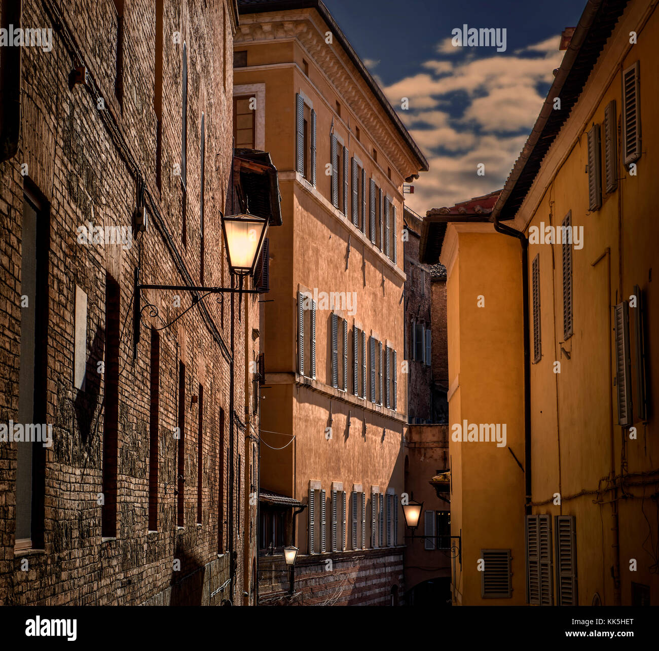 lighted up Street lights in Siena, Italy on dusk Stock Photo - Alamy