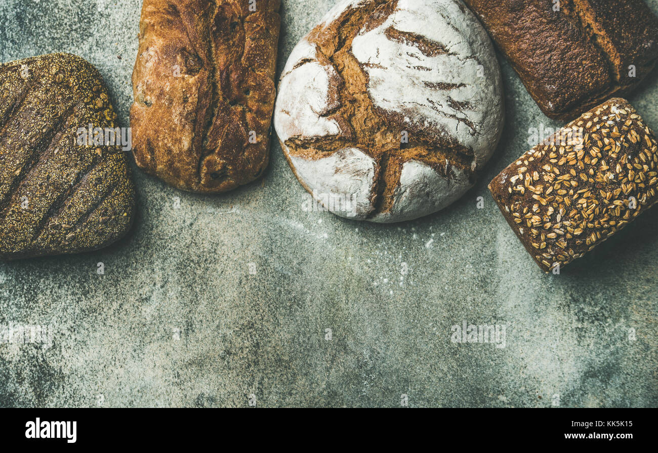 Top view of rustic bread loaves over grey background Stock Photo - Alamy