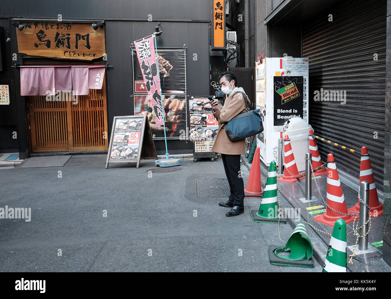 Man check his phone at backstreet in Tokyo Stock Photo - Alamy