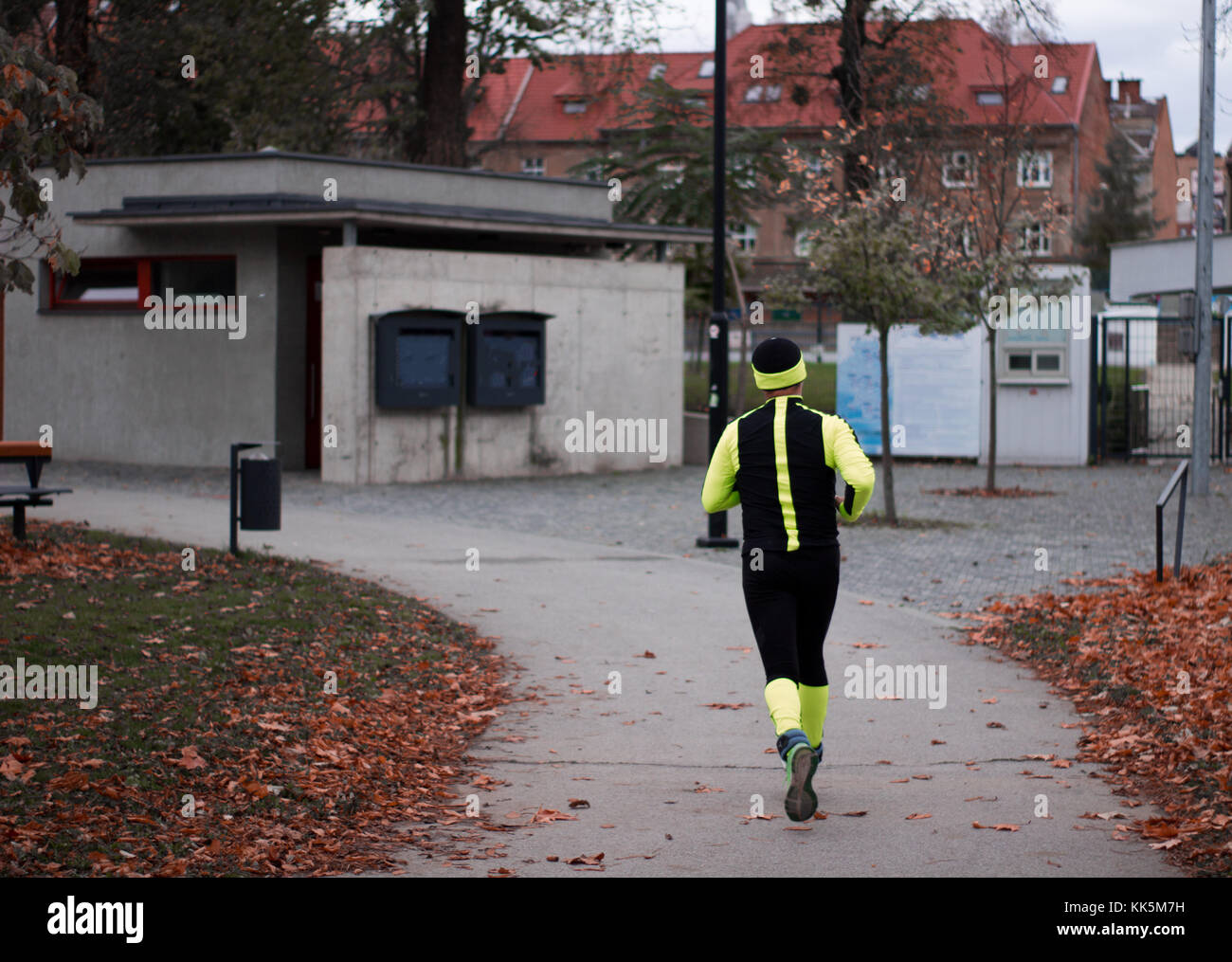 runner running at an autumn scenery park at a beautiful morning alone ...