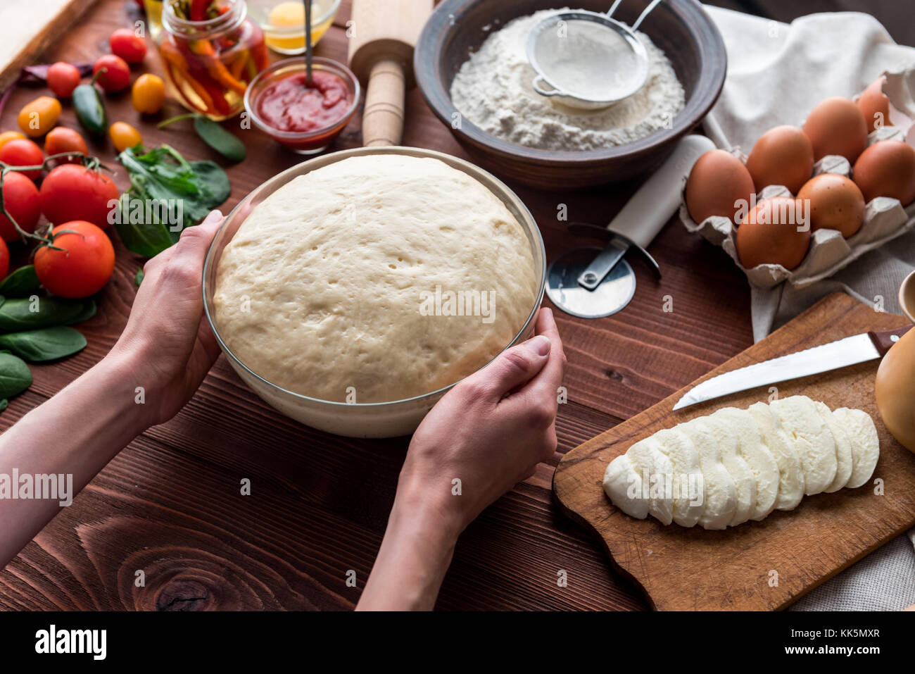 Step-by-step boss makes a pizza margarita. Dough and pizza ingredients ...