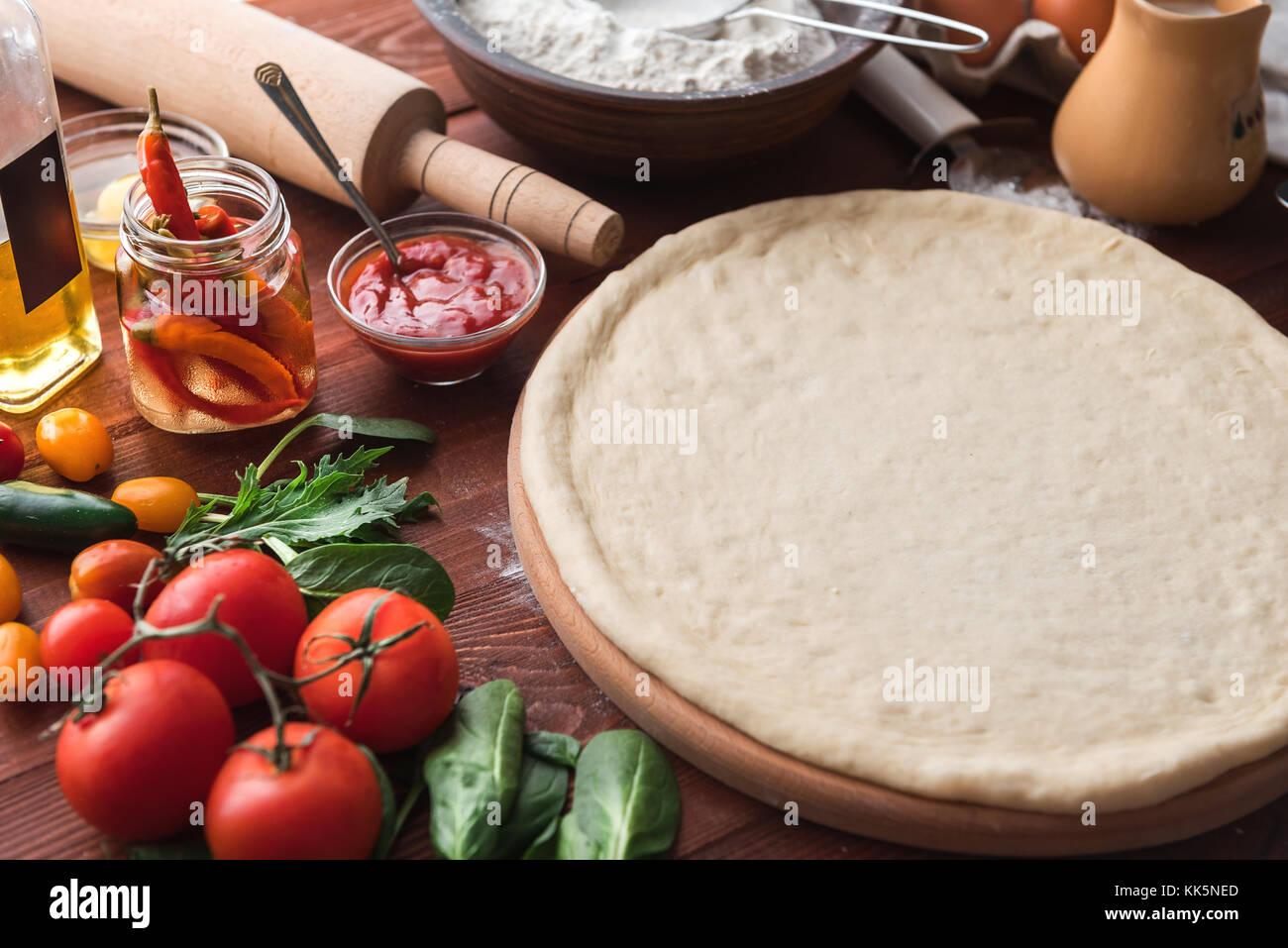 Step-by-step boss makes a pizza margarita. Dough and pizza ingredients ...