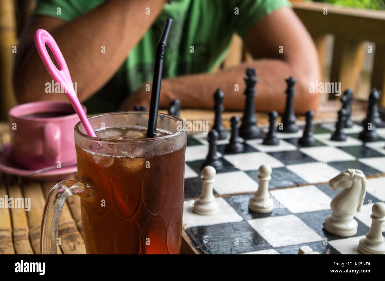Ice tea and coffee while playing chess Stock Photo - Alamy