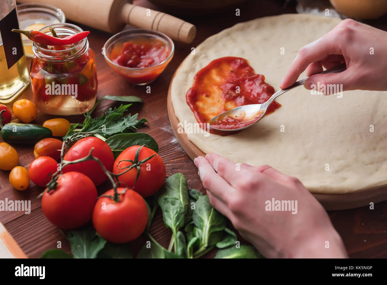 Step-by-step boss makes a pizza margarita. Dough and pizza ingredients ...