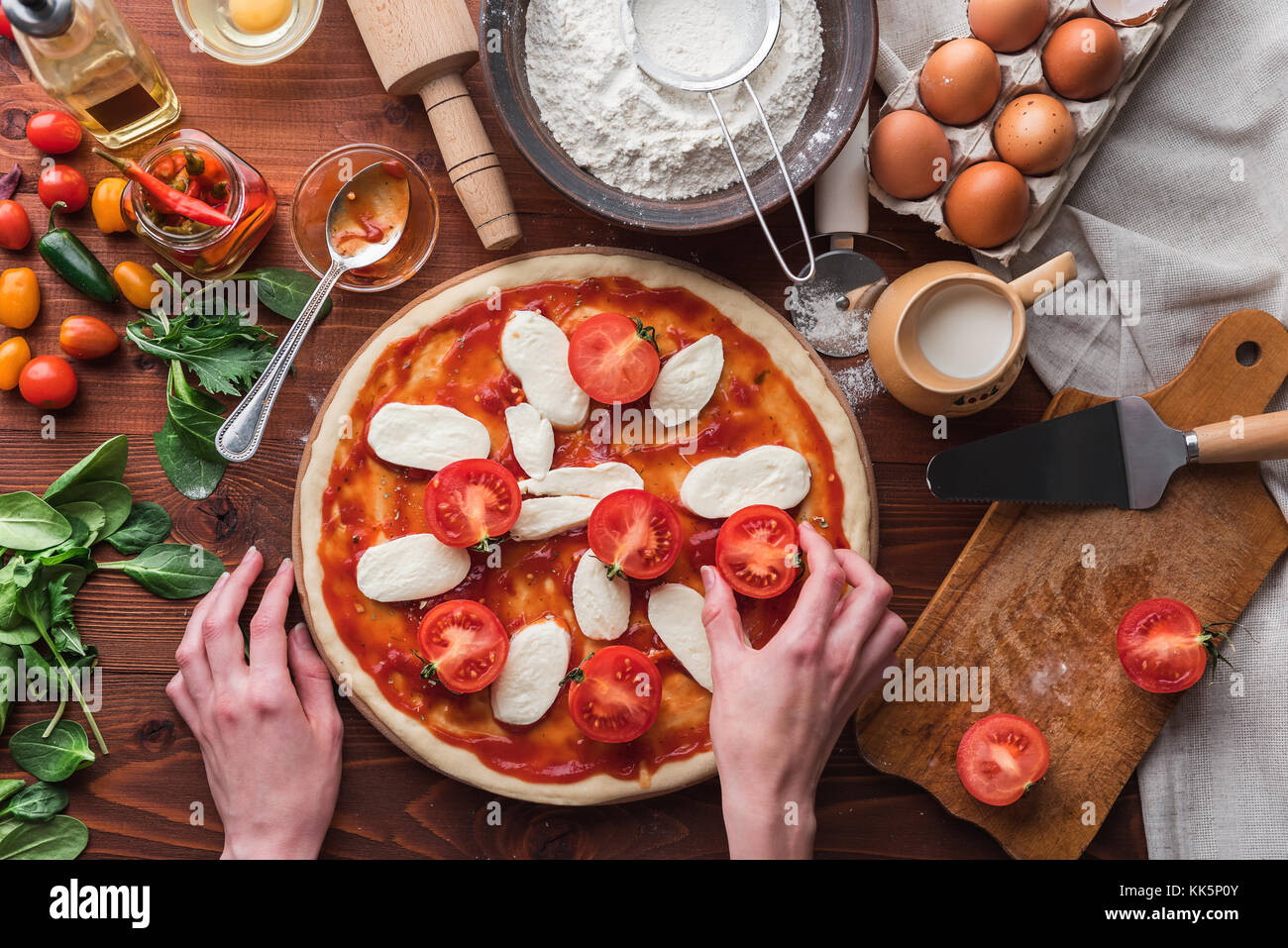 Step-by-step boss makes a pizza margarita. Dough and pizza ingredients ...