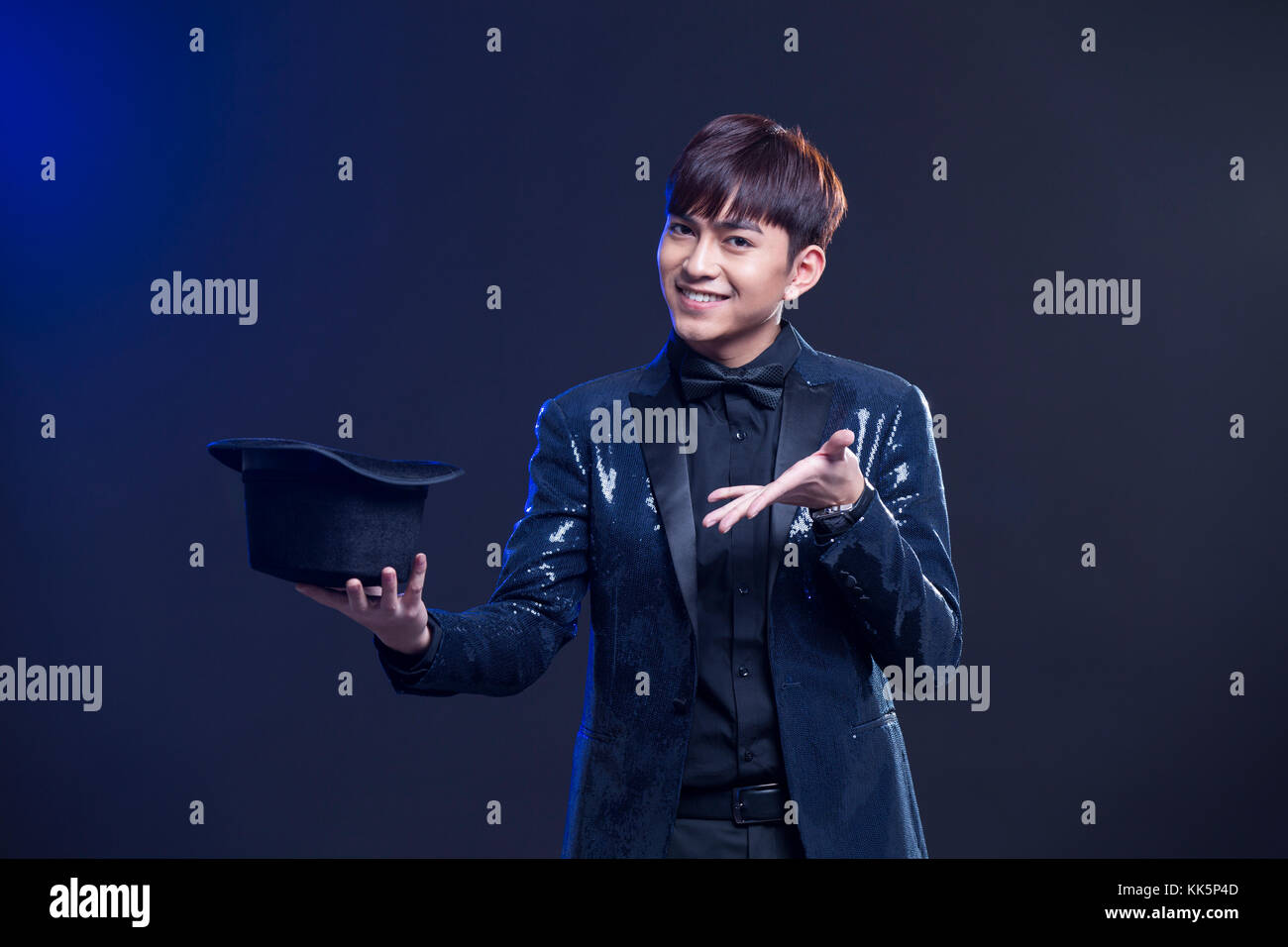 Young Chinese magician performing magic trick Stock Photo - Alamy