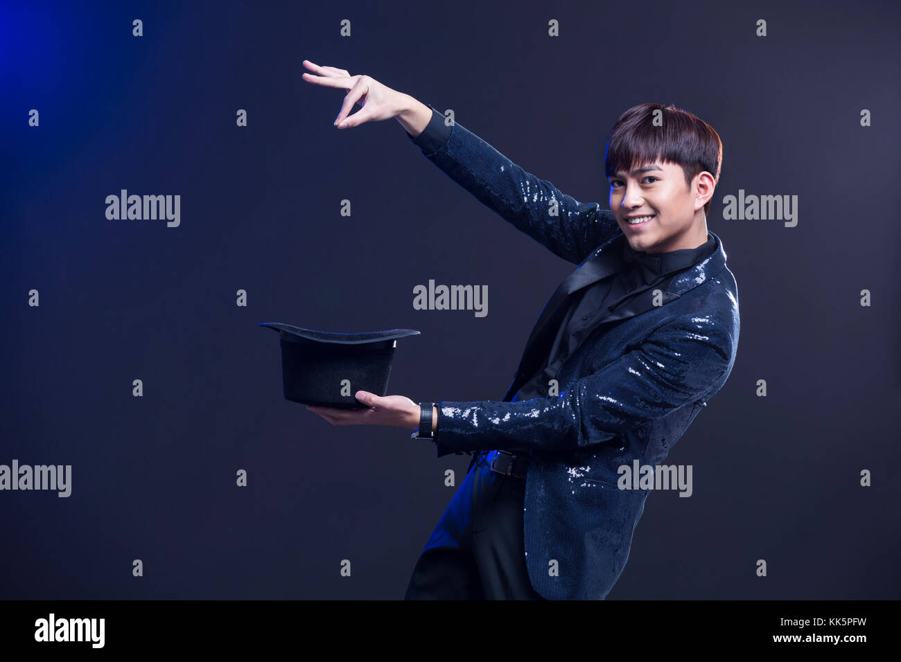 Young Chinese magician performing magic trick Stock Photo - Alamy