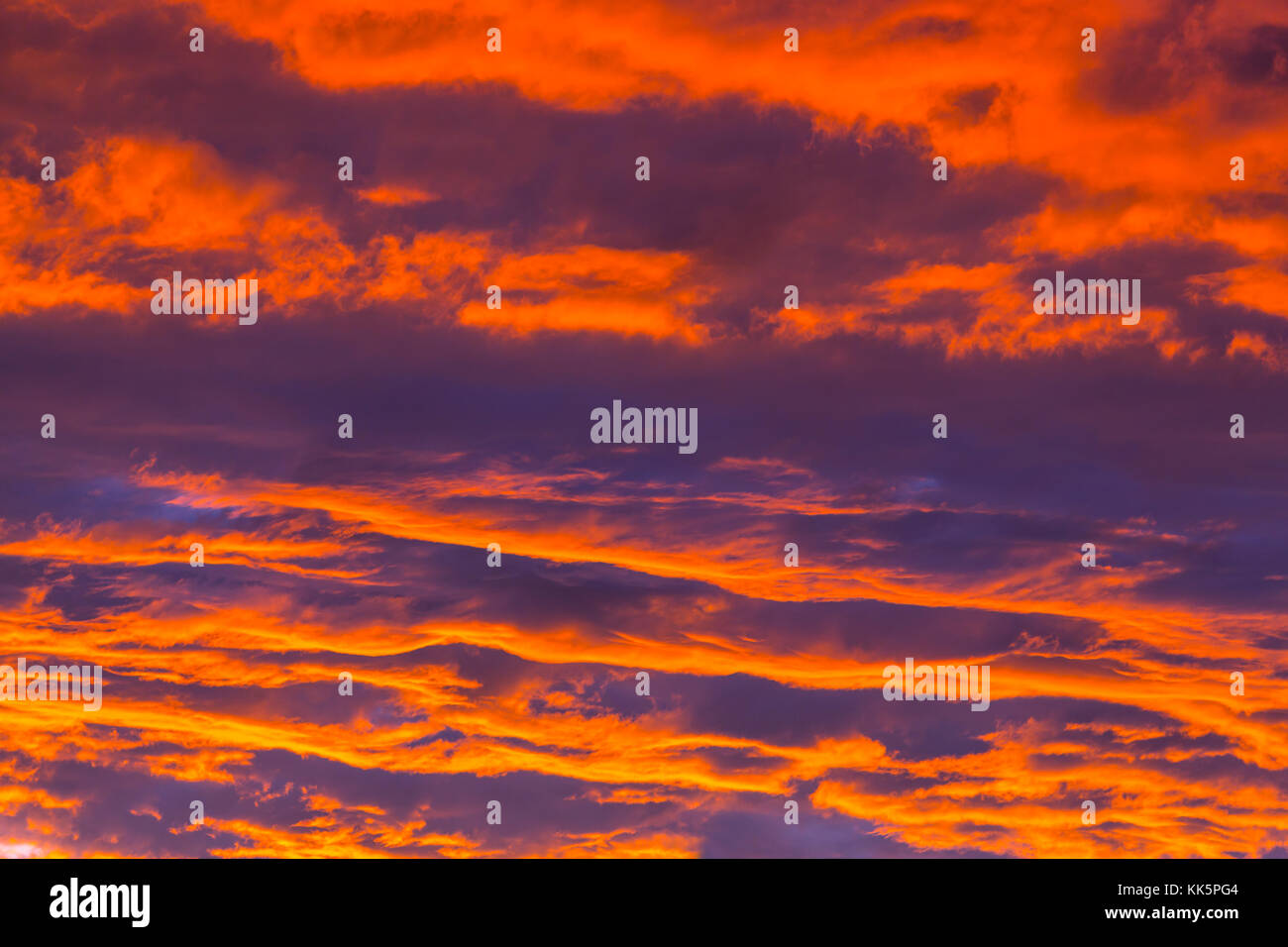 Unusual storm clouds at sunset. Bright red and orange colors of the sky ...