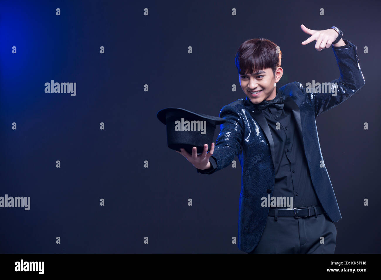 Young Chinese magician performing magic trick Stock Photo - Alamy