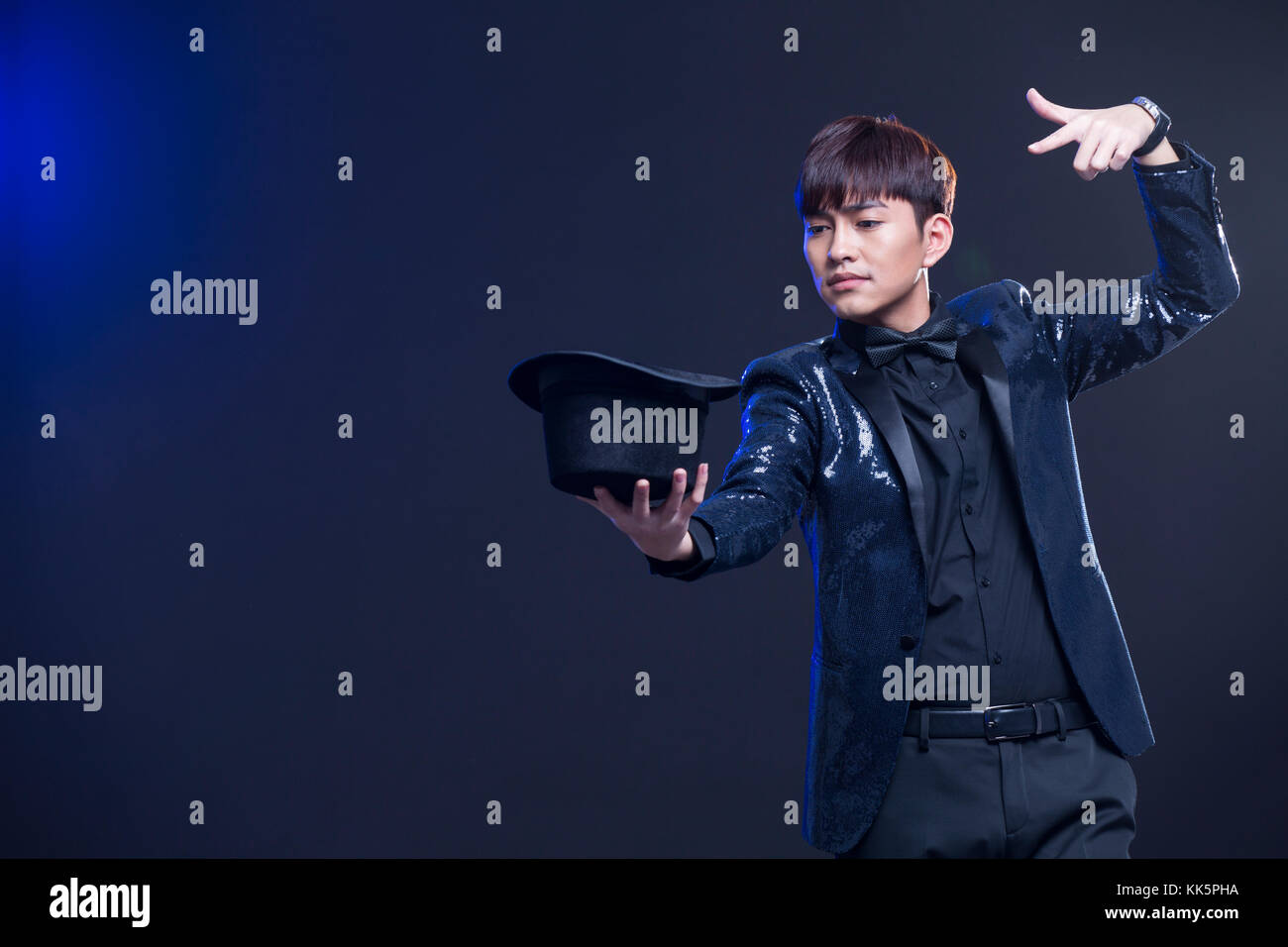 Young Chinese magician performing magic trick Stock Photo - Alamy