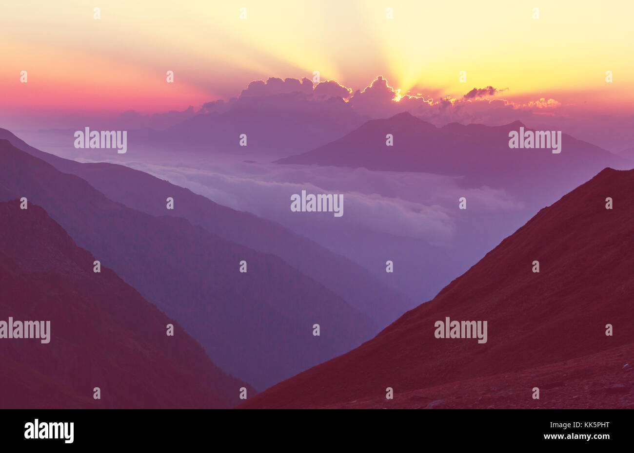 Sunset in mountains Stock Photo - Alamy