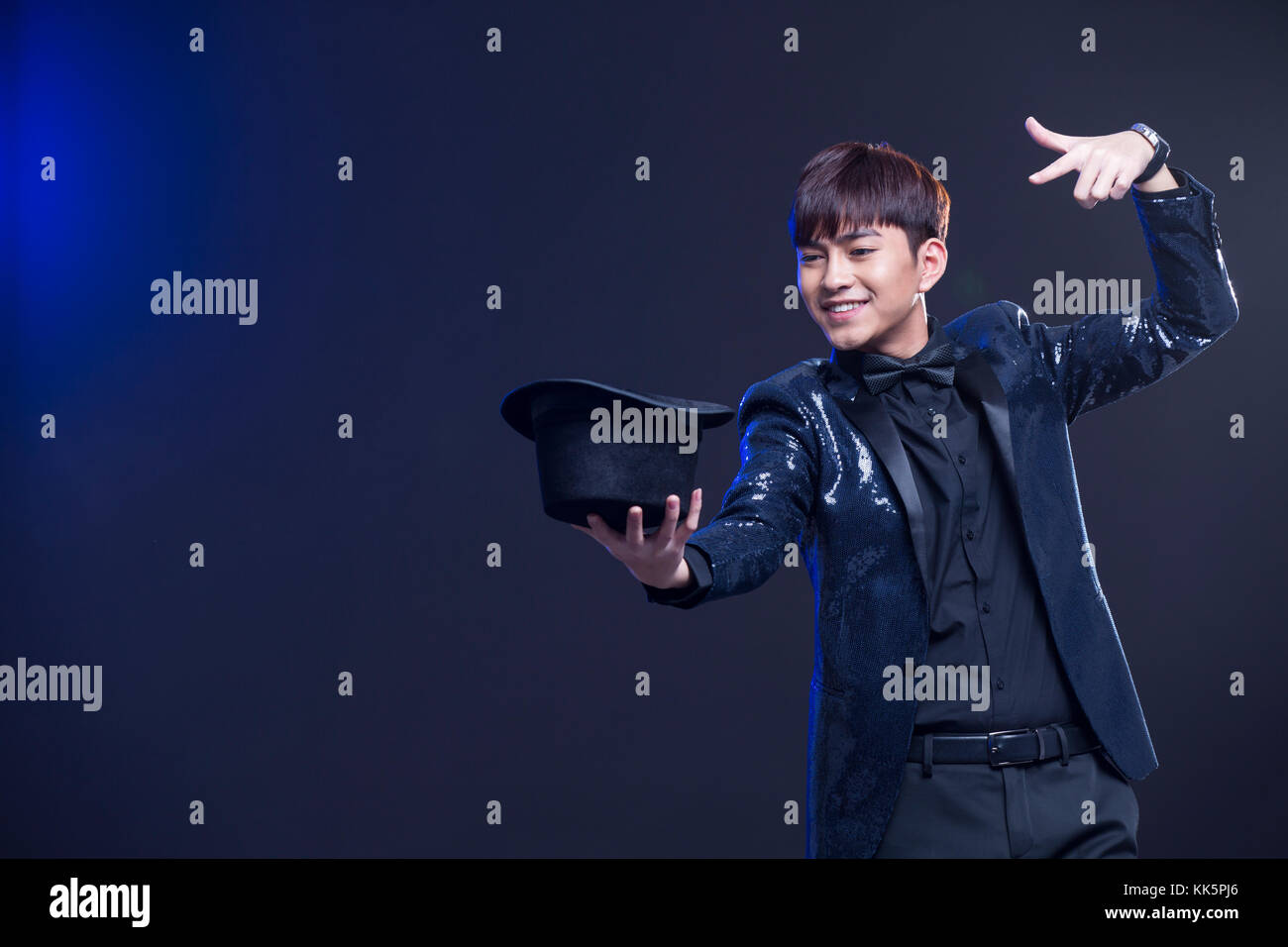 Young Chinese magician performing magic trick Stock Photo - Alamy