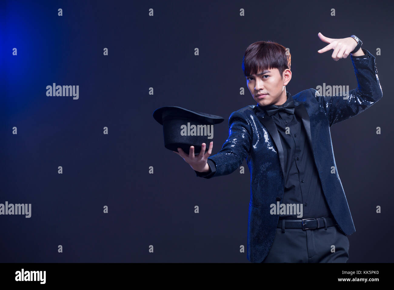 Young Chinese magician performing magic trick Stock Photo - Alamy