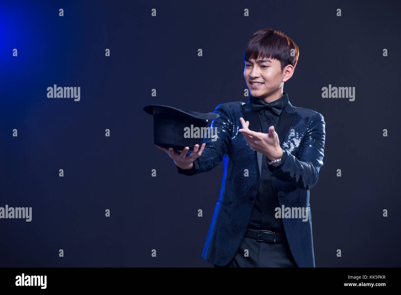 Young Chinese magician performing magic trick Stock Photo - Alamy