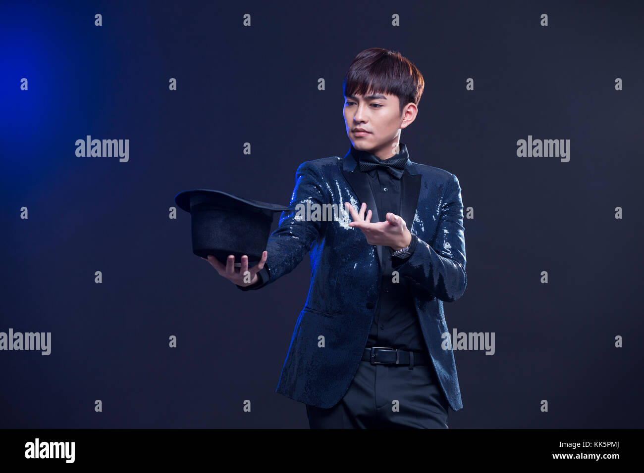 Young Chinese magician performing magic trick Stock Photo - Alamy