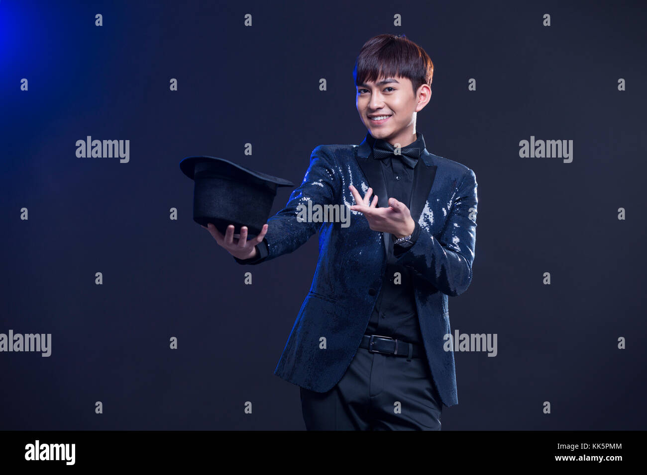 Young Chinese magician performing magic trick Stock Photo - Alamy