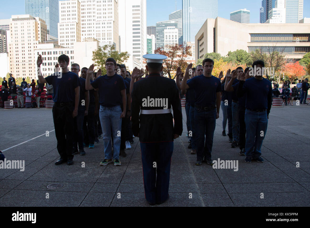 More than 20 future Marines raise their right hand as they take the ...