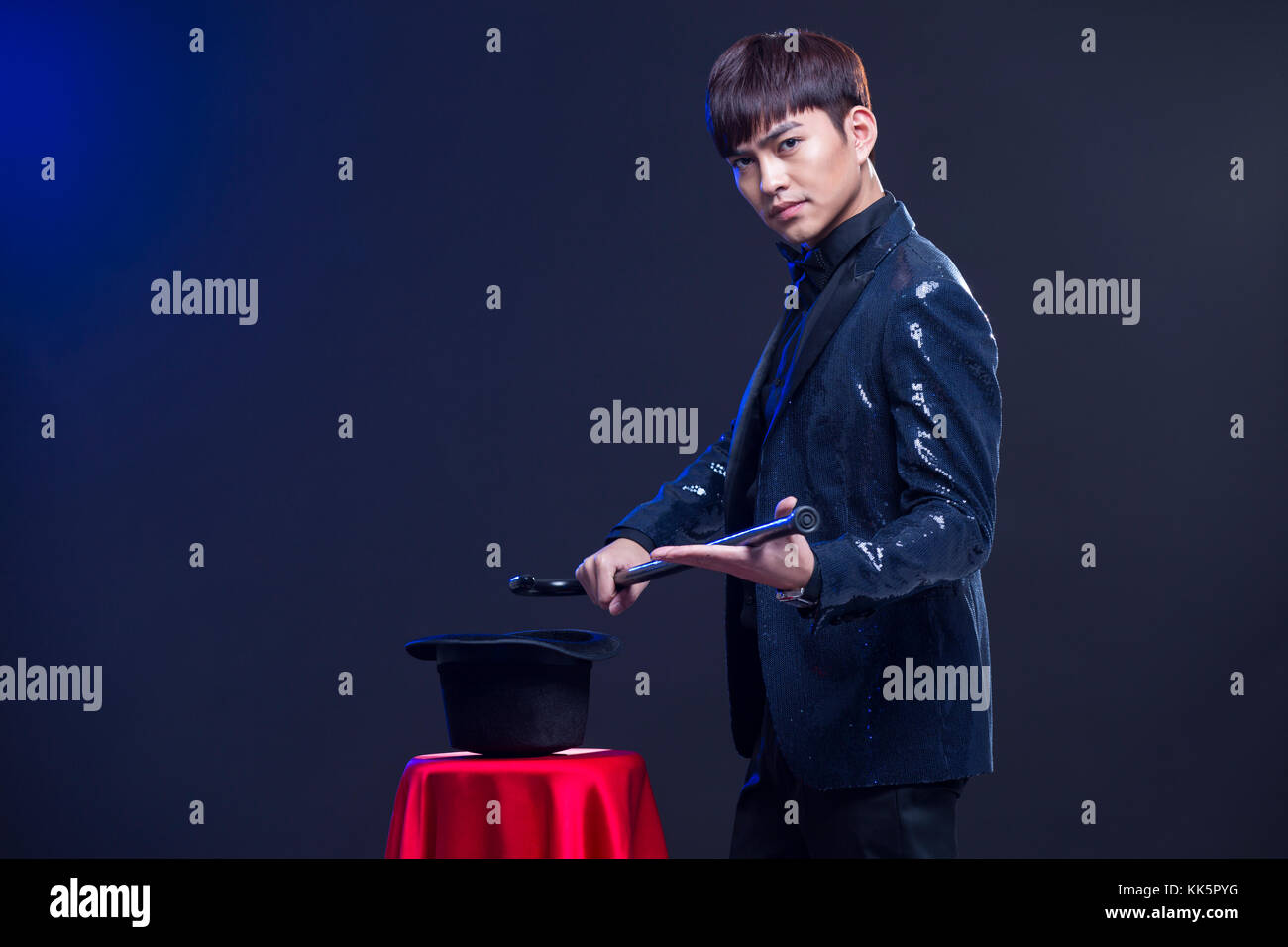 Young Chinese magician performing magic trick Stock Photo - Alamy