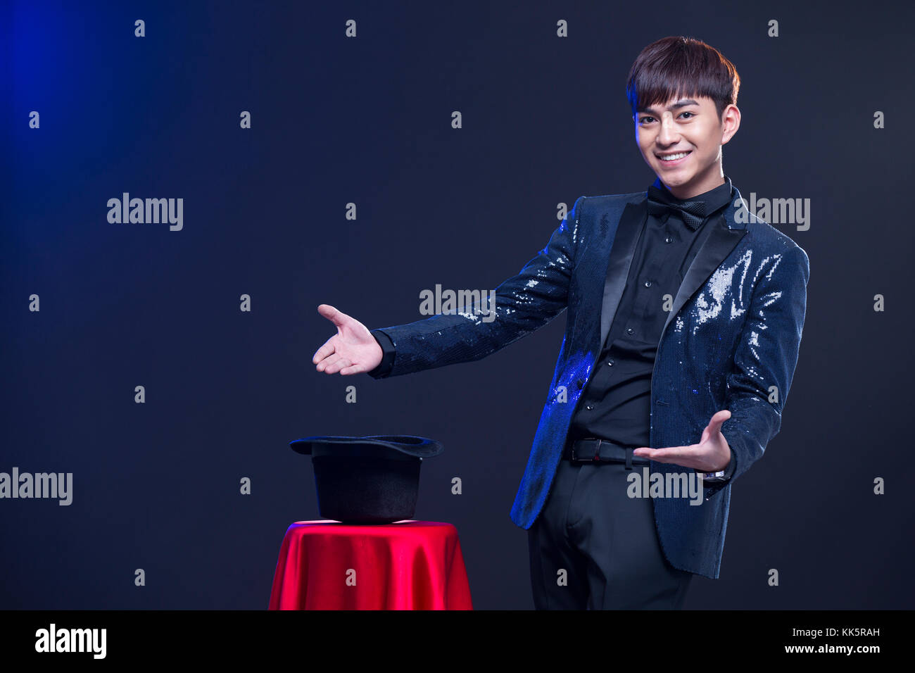 Young Chinese magician performing magic trick Stock Photo - Alamy