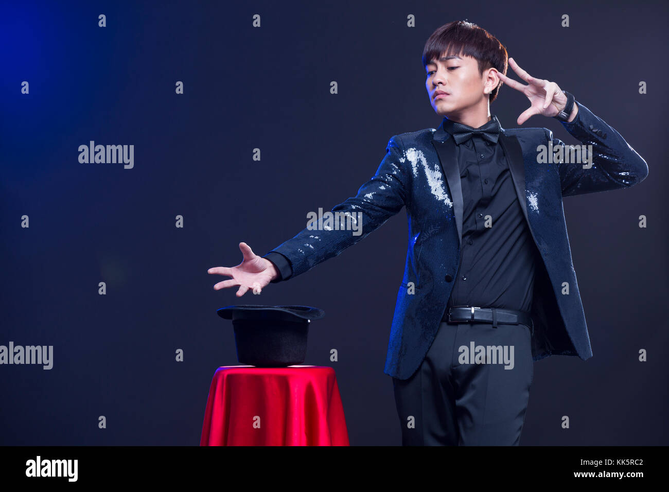Young Chinese magician performing magic trick Stock Photo - Alamy