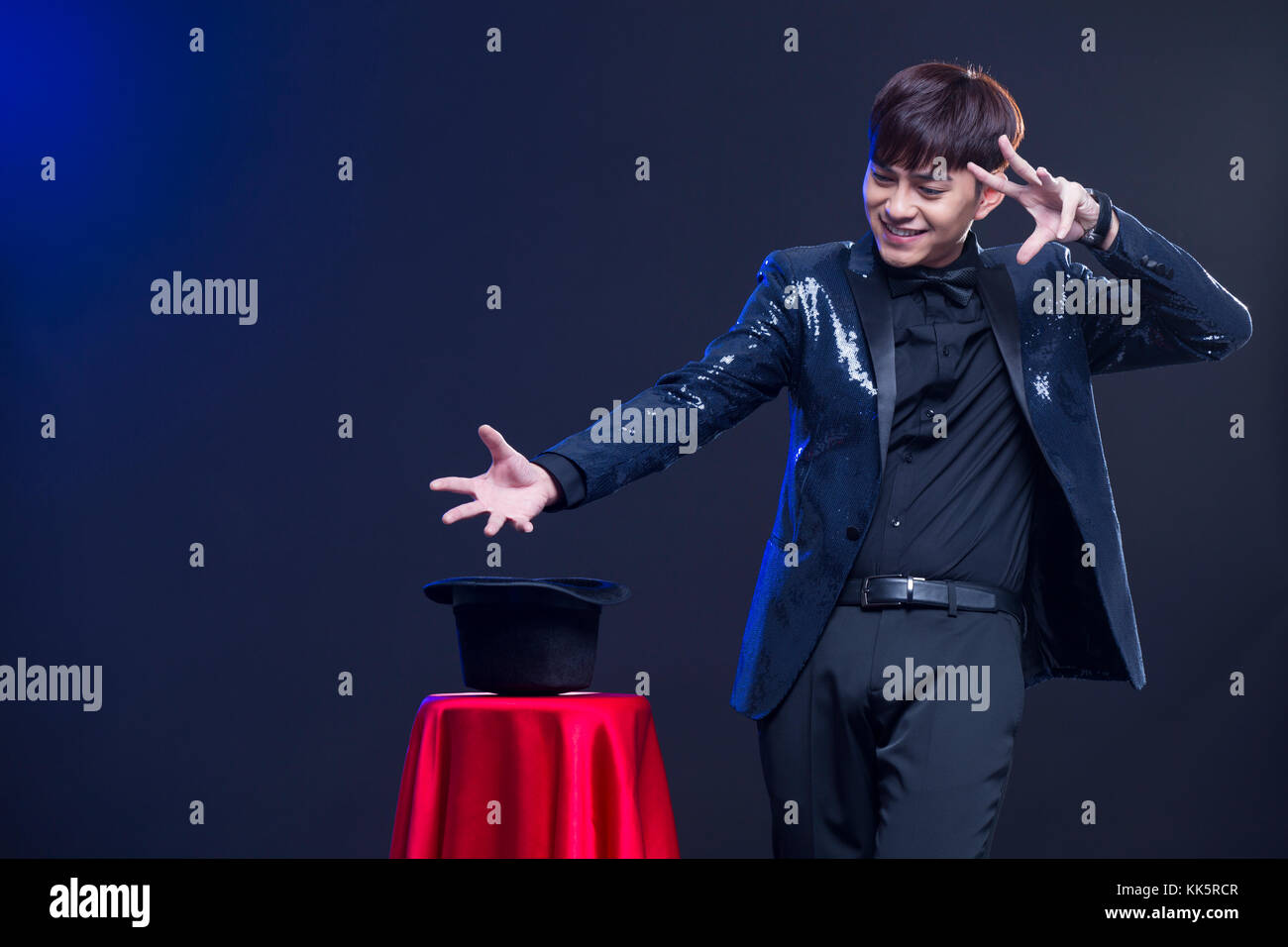 Young Chinese magician performing magic trick Stock Photo - Alamy